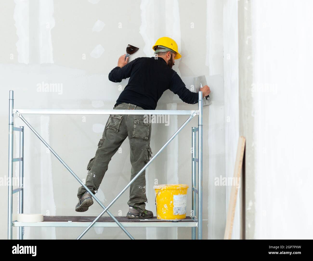 Interior construction, worker plastering gypsum board wall Stock Photo ...