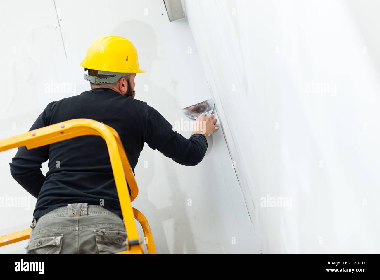 Interior construction, worker plastering gypsum board wall Stock Photo ...