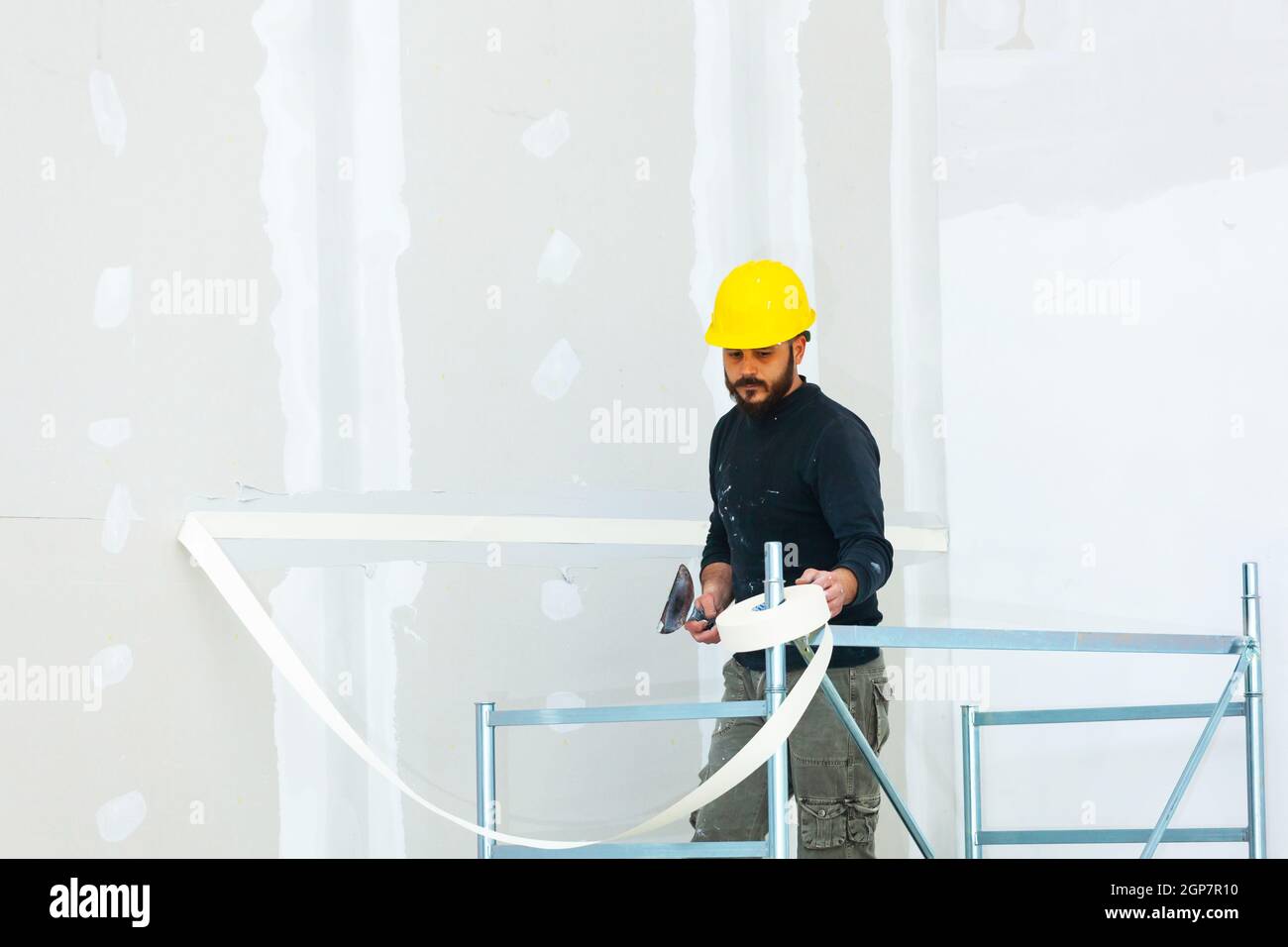 Interior construction, worker plastering gypsum board wall Stock Photo ...