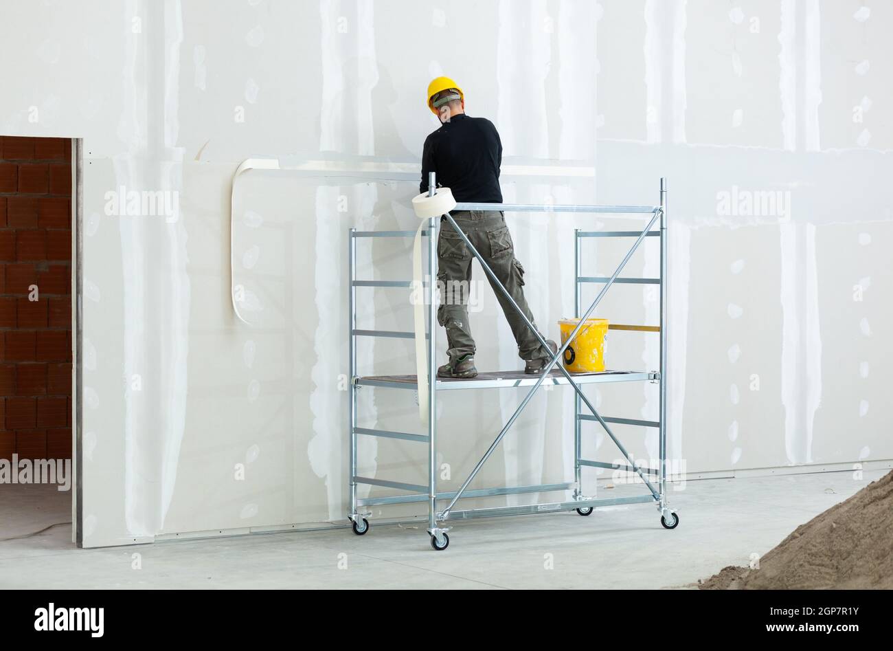 Interior construction, worker plastering gypsum board wall Stock Photo ...