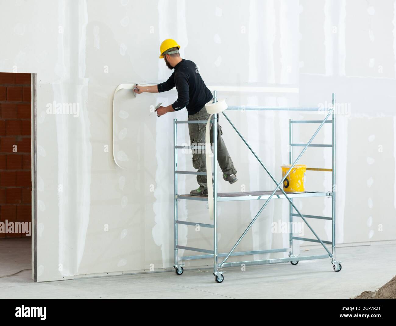 Interior construction, worker plastering gypsum board wall Stock Photo ...