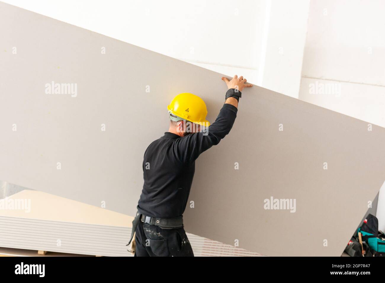 Worker at work in the construction of a plasterboard wall Stock Photo ...