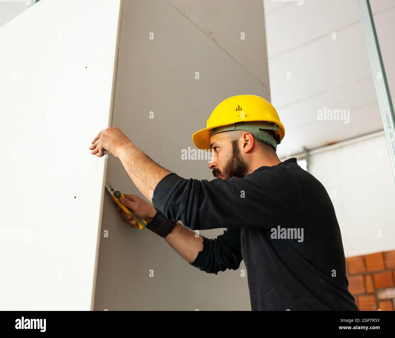 Worker at work in the construction of a plasterboard wall Stock Photo ...