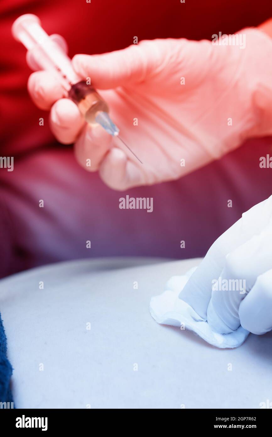 Injection syringe with medicine on the buttock Stock Photo - Alamy
