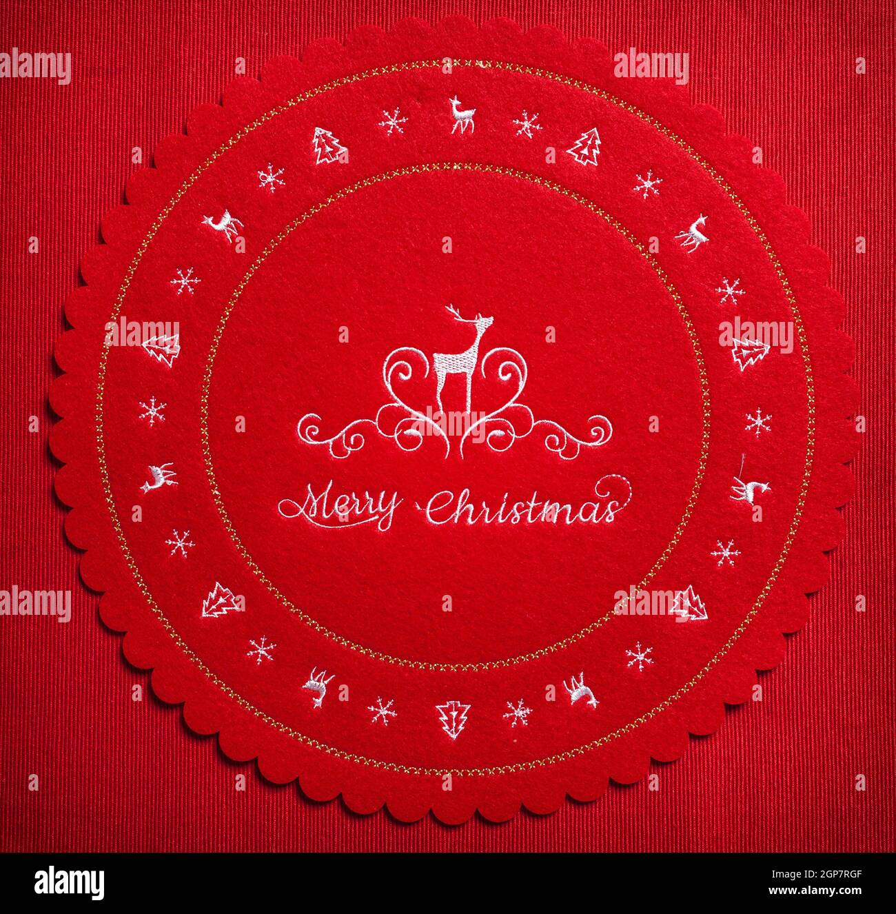 Red fabric cloth or tablemat with Merry Christmas text Stock Photo - Alamy