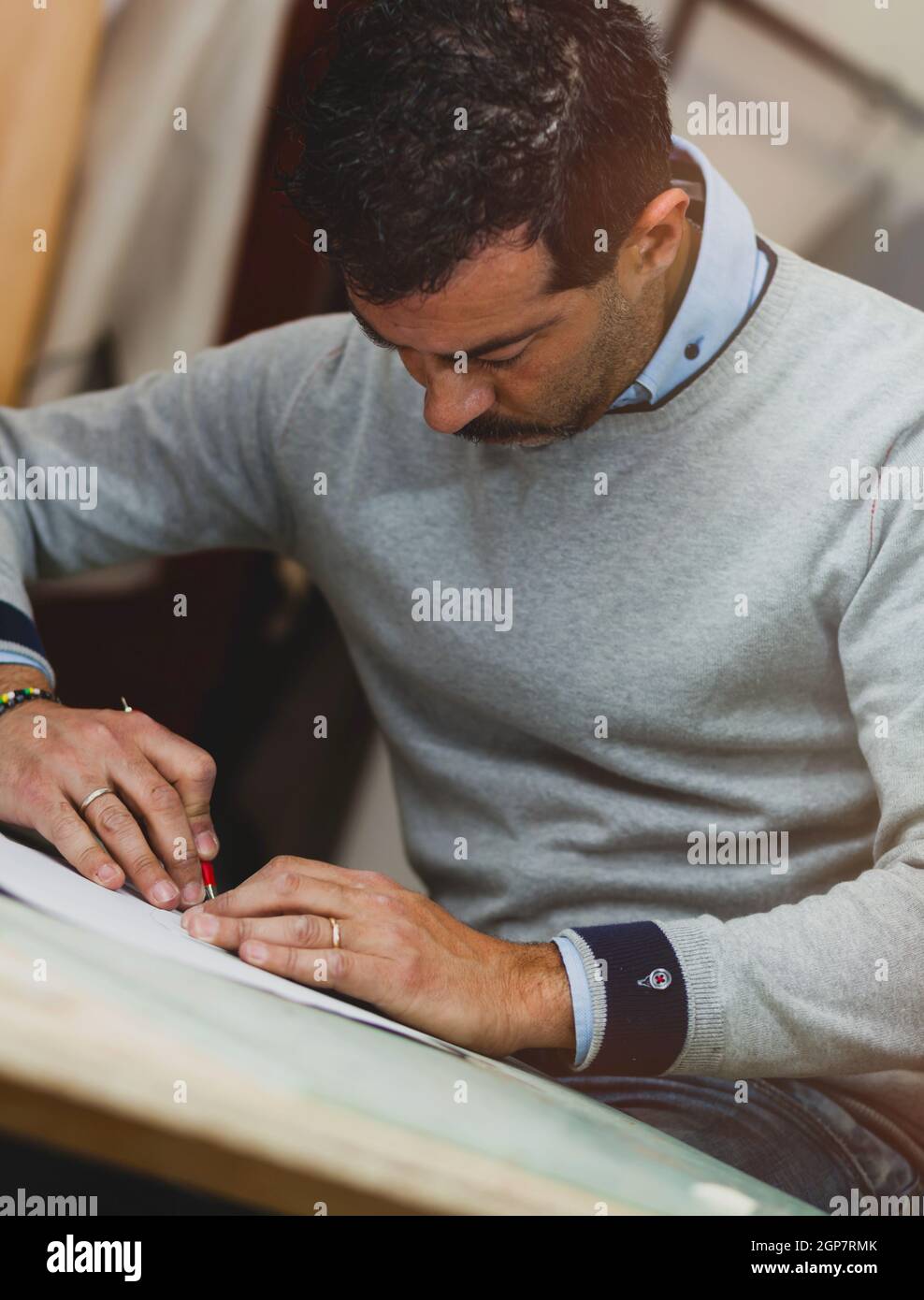 Shoemaker or shoe designer working with lwith paper models for leather ...