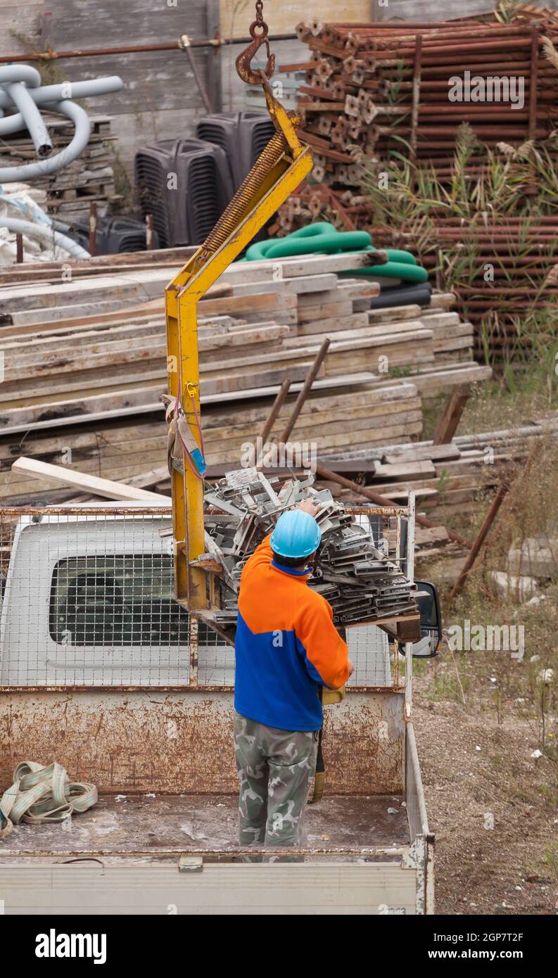 Workers at the construction site with the crane moving steel Stock ...