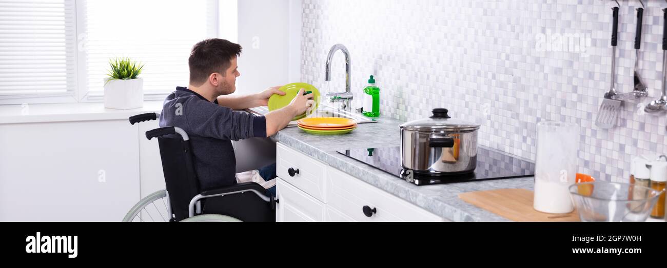 Man With Handicap Disability Washing Dishes In Kitchen Stock Photo - Alamy