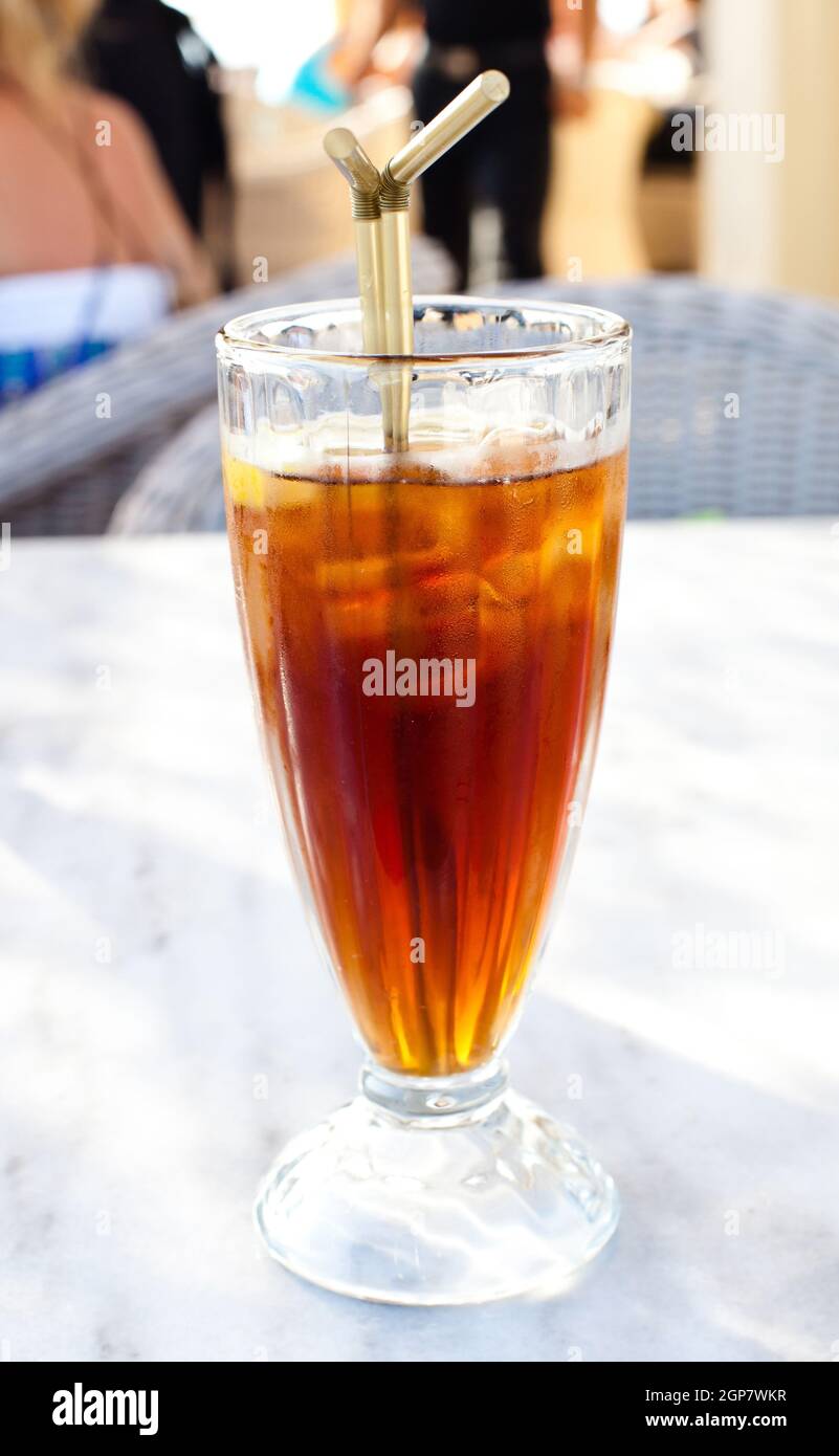 Cold iced tea with straw Stock Photo - Alamy