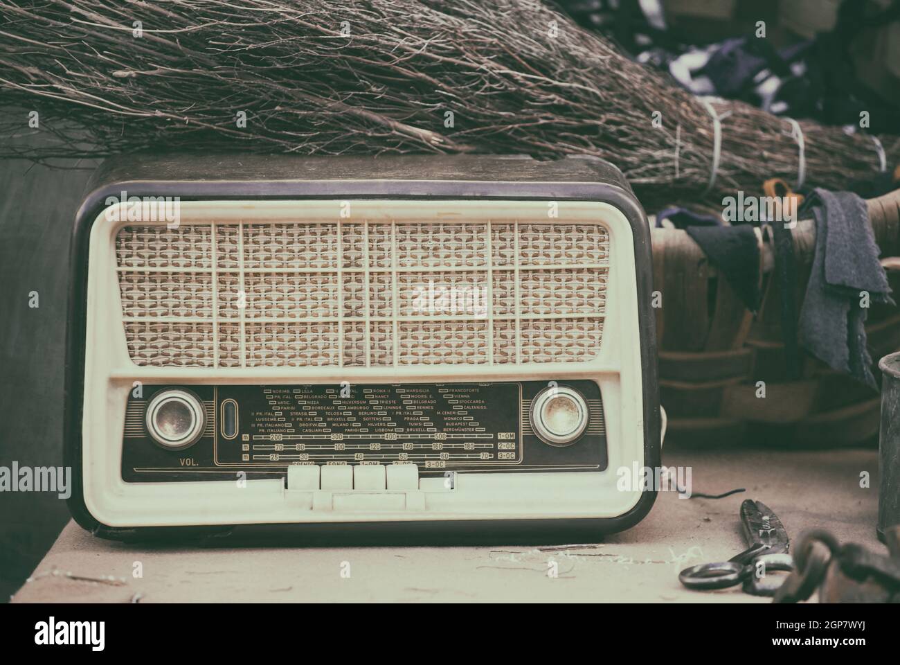 Vintage radio on wood table with various utensils Stock Photo - Alamy