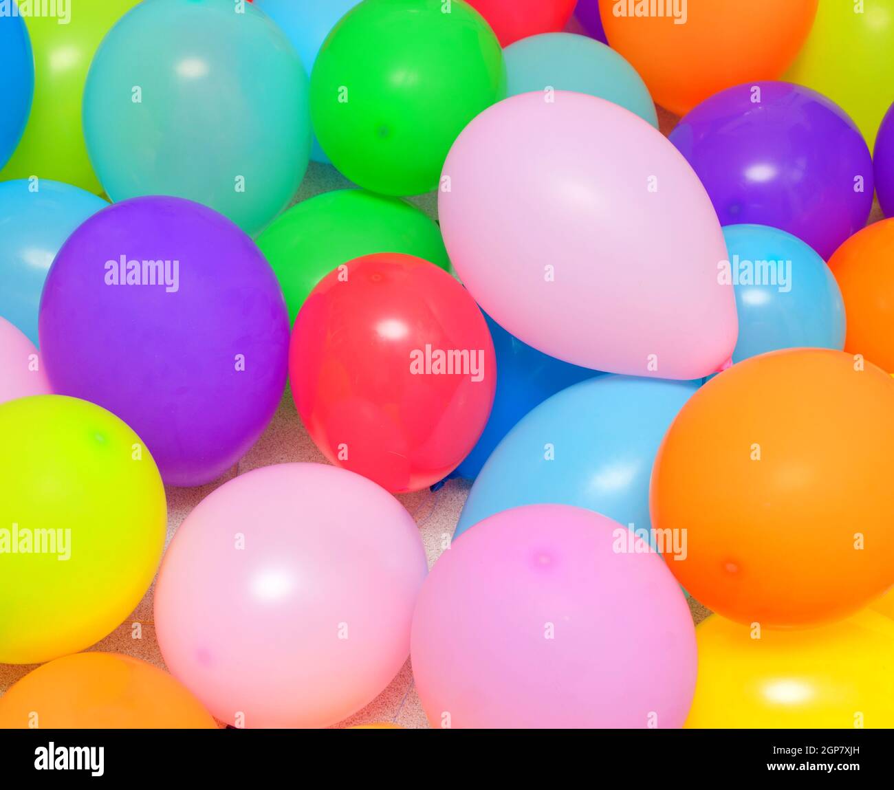 Balloons of many colours in a large pile Stock Photo - Alamy