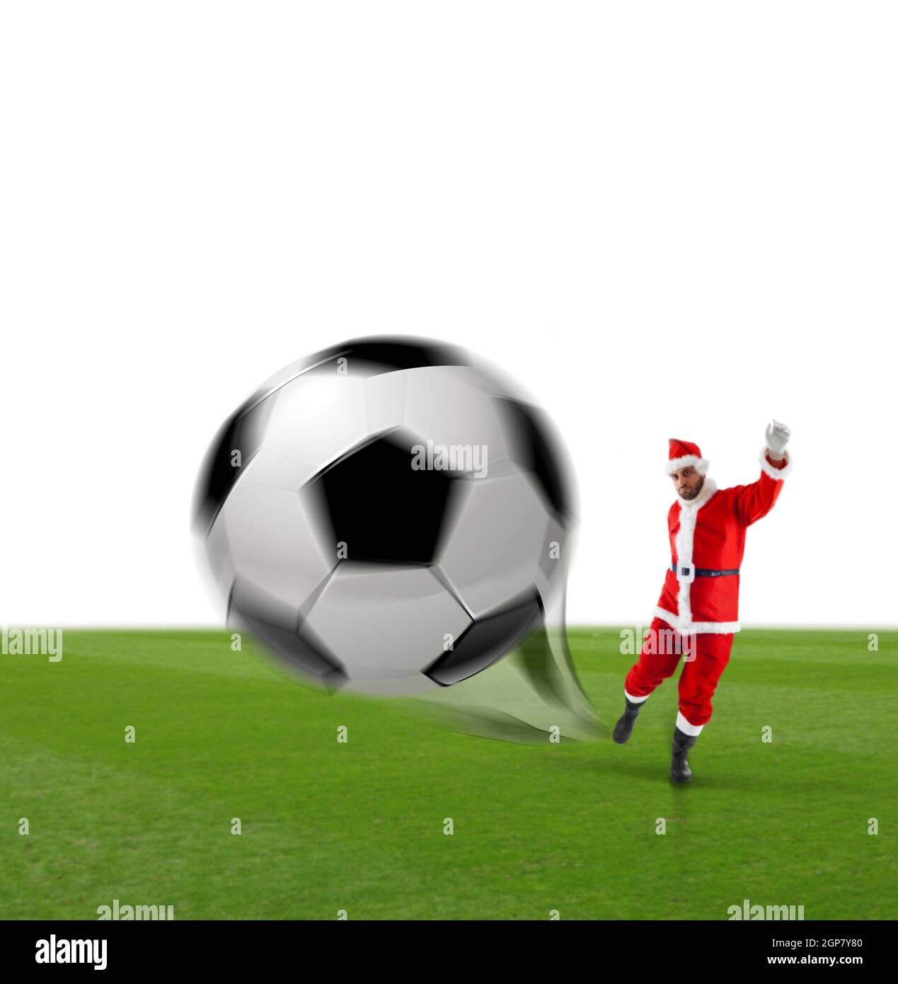 Santa Calus kicking a soccer ball on the grass and white background ...