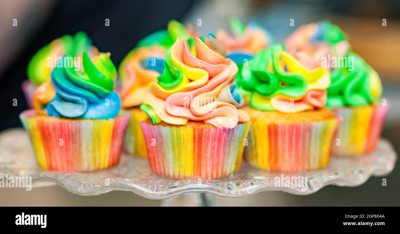 Colorful cupcakes with rainbow cream for Carnival Stock Photo - Alamy