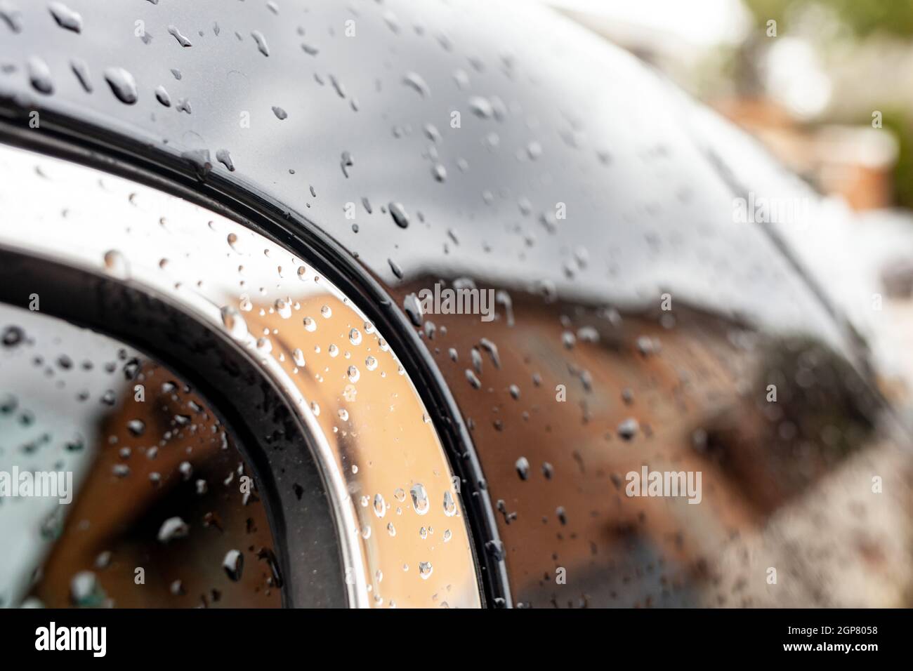Detail of the black bodywork and the chrome profiles of the car with ...