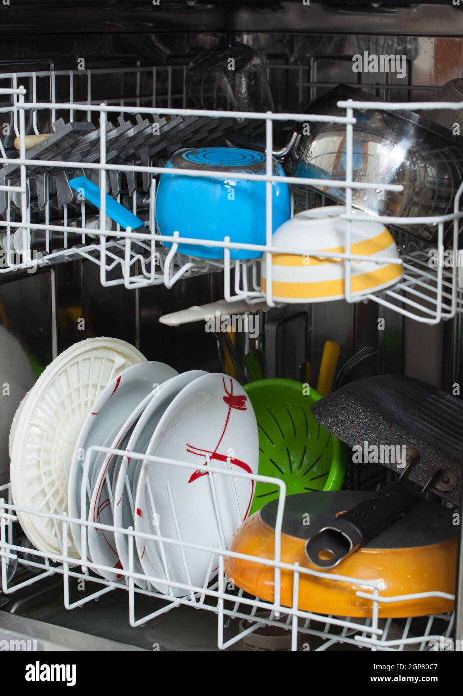 Dirty dishes loaded in a dishwasher with opened front door Stock Photo ...