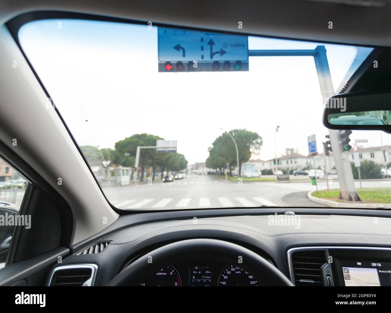 View from inside a car on a part of dashboard with a navigation unit ...