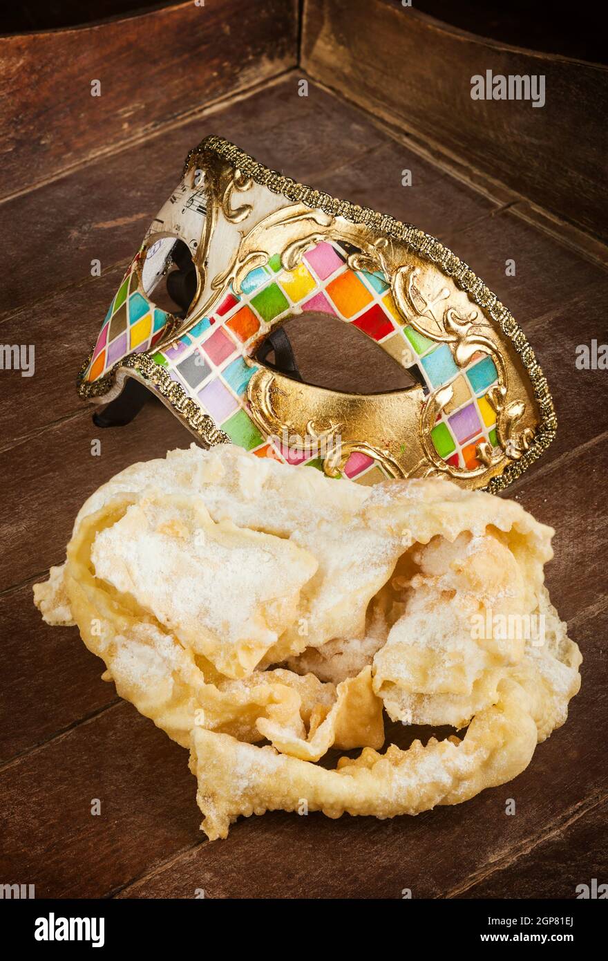 Typical fried pastry of italian carnival with venetian mask. These ...