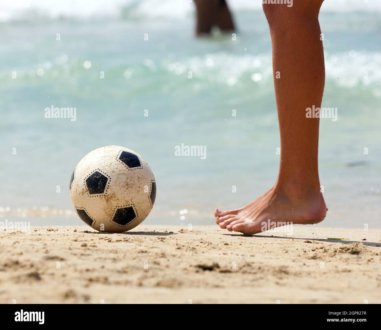 Close up of male foot playing football on sand Stock Photo - Alamy