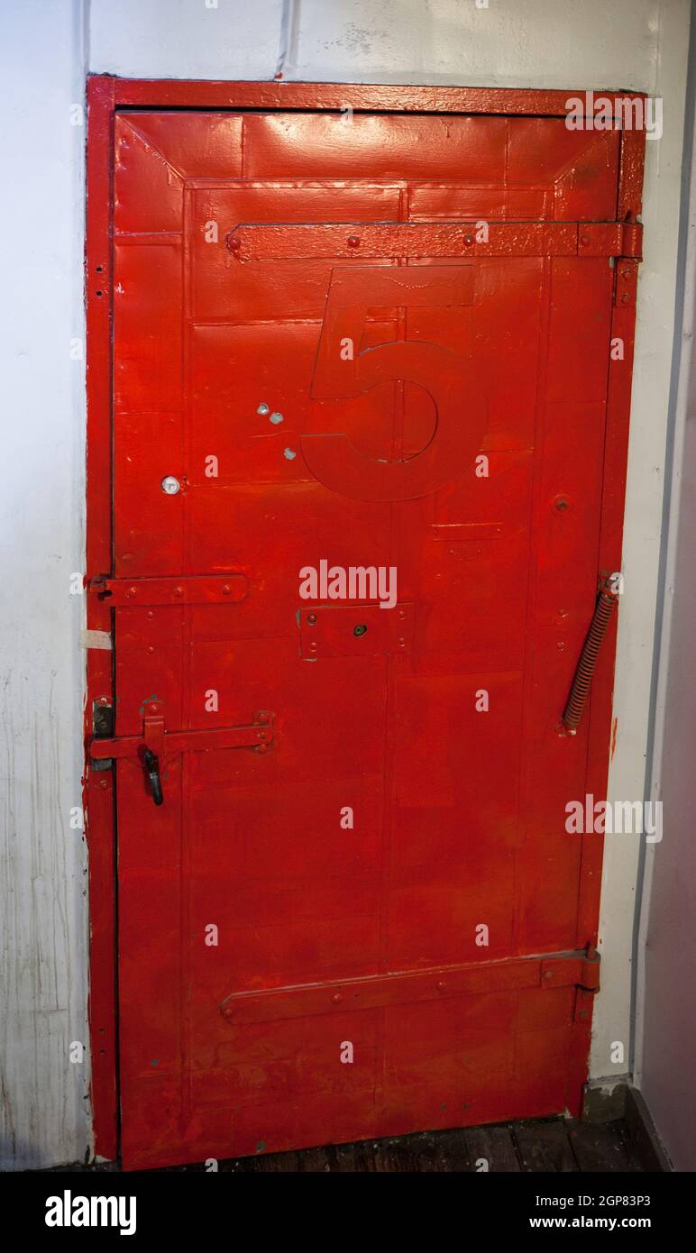 Vintage fire door painted red with number five Stock Photo - Alamy