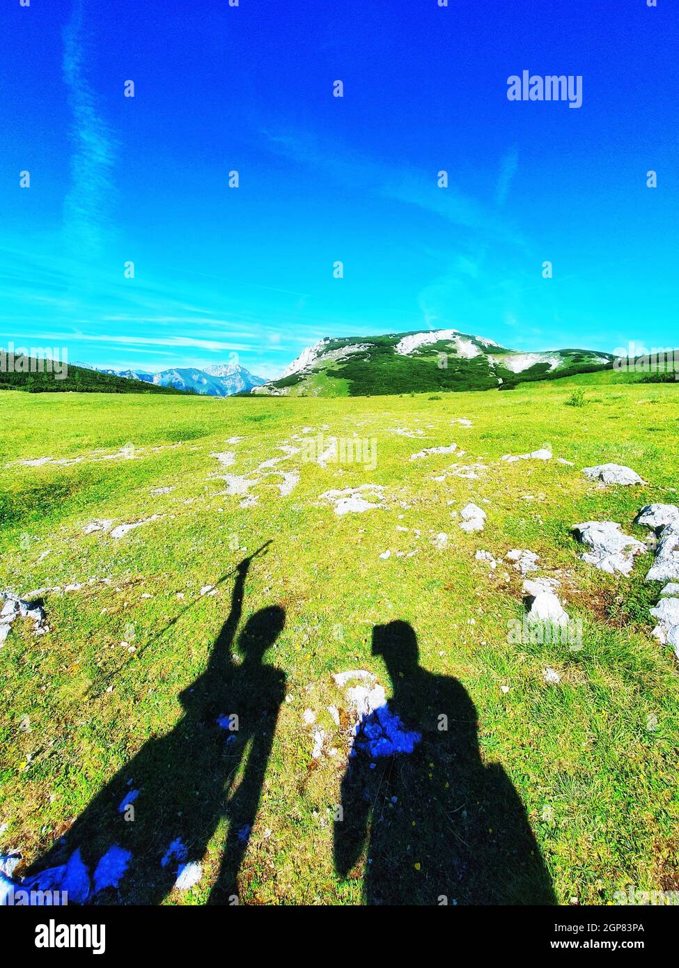 Vertical shot of the shadows of two hikers in a mountain Stock Photo ...