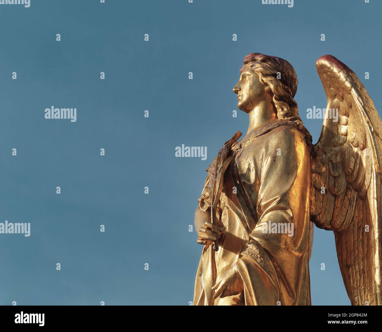 Low angle shot of a gold angel statue holding a feather in Zagreb ...