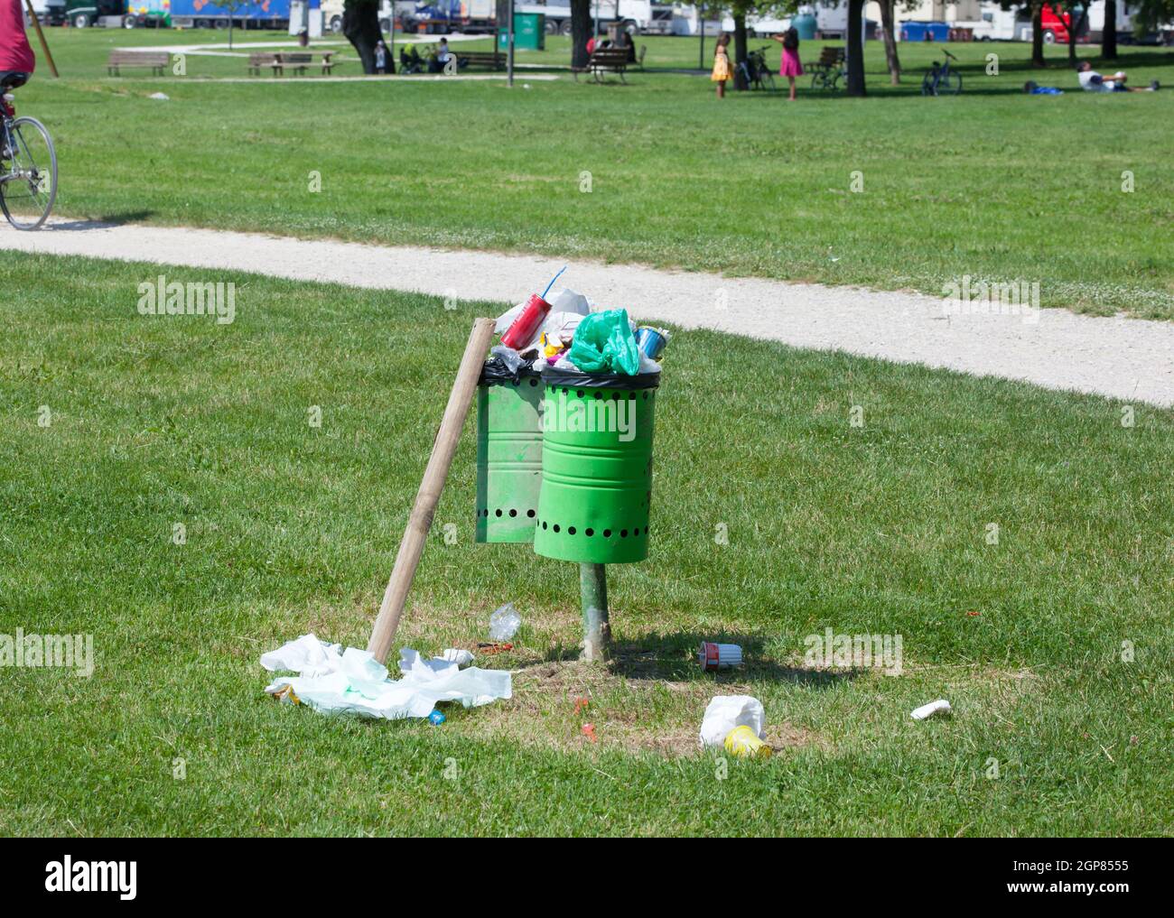 Trash bin full with wastes on the groundl in an outdoor park Stock ...