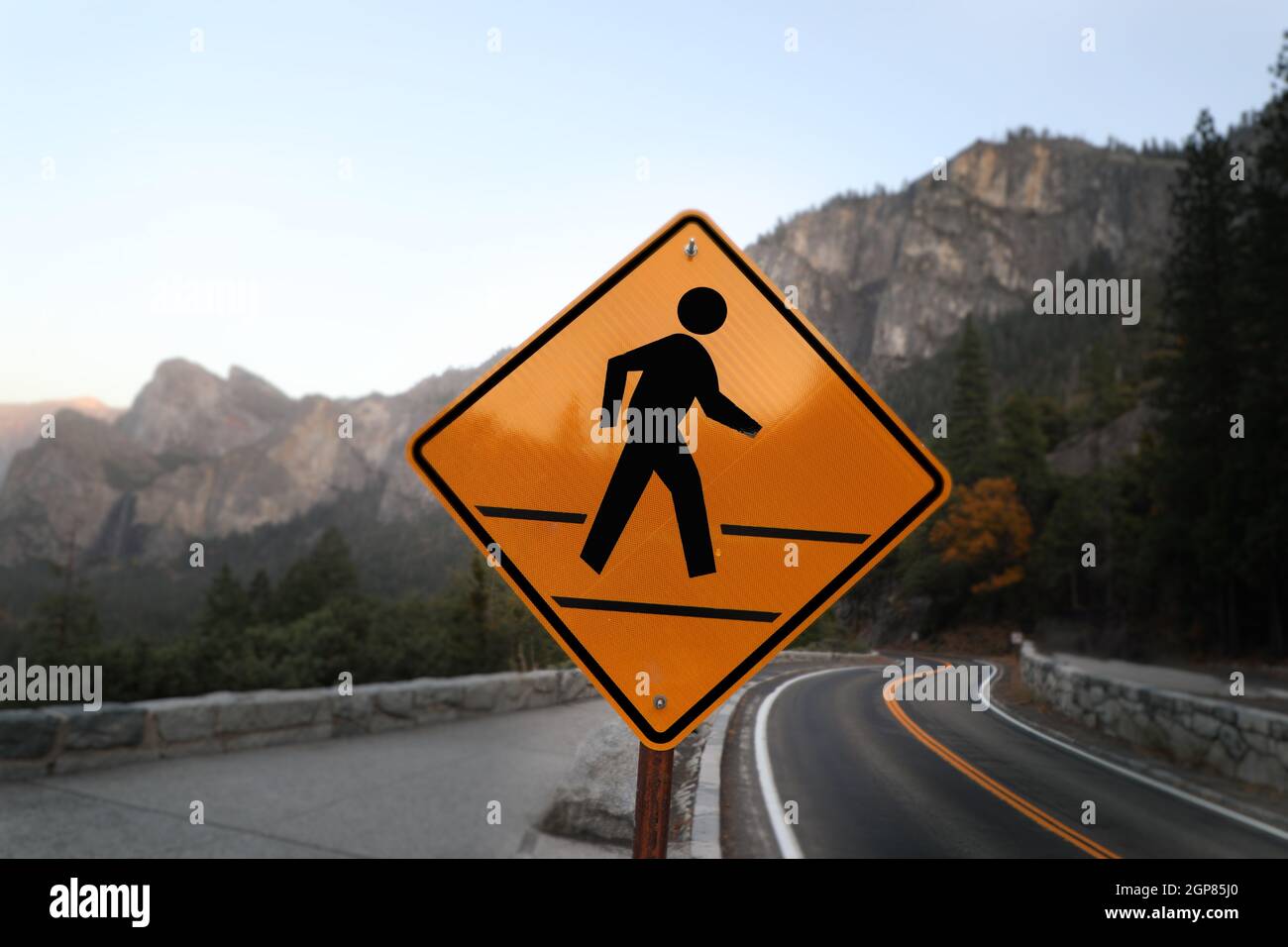 Pedestrian traffic sign with mountains in the background Stock Photo ...