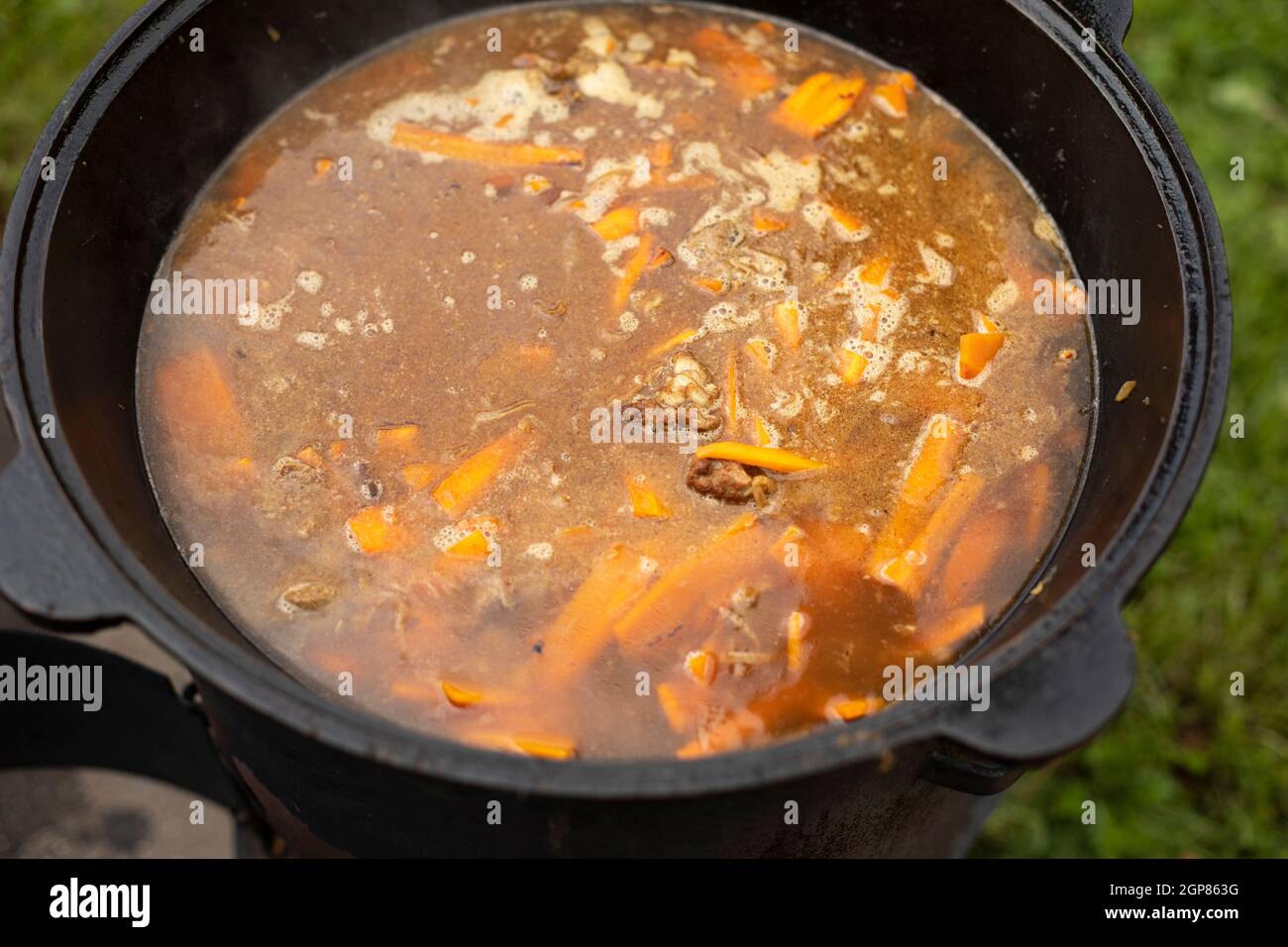 Soup in a pot. Food outside. Cooking soup on an open fire. National ...