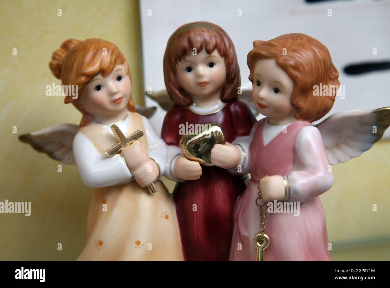 Three porcelain angels in a shop-window Stock Photo - Alamy