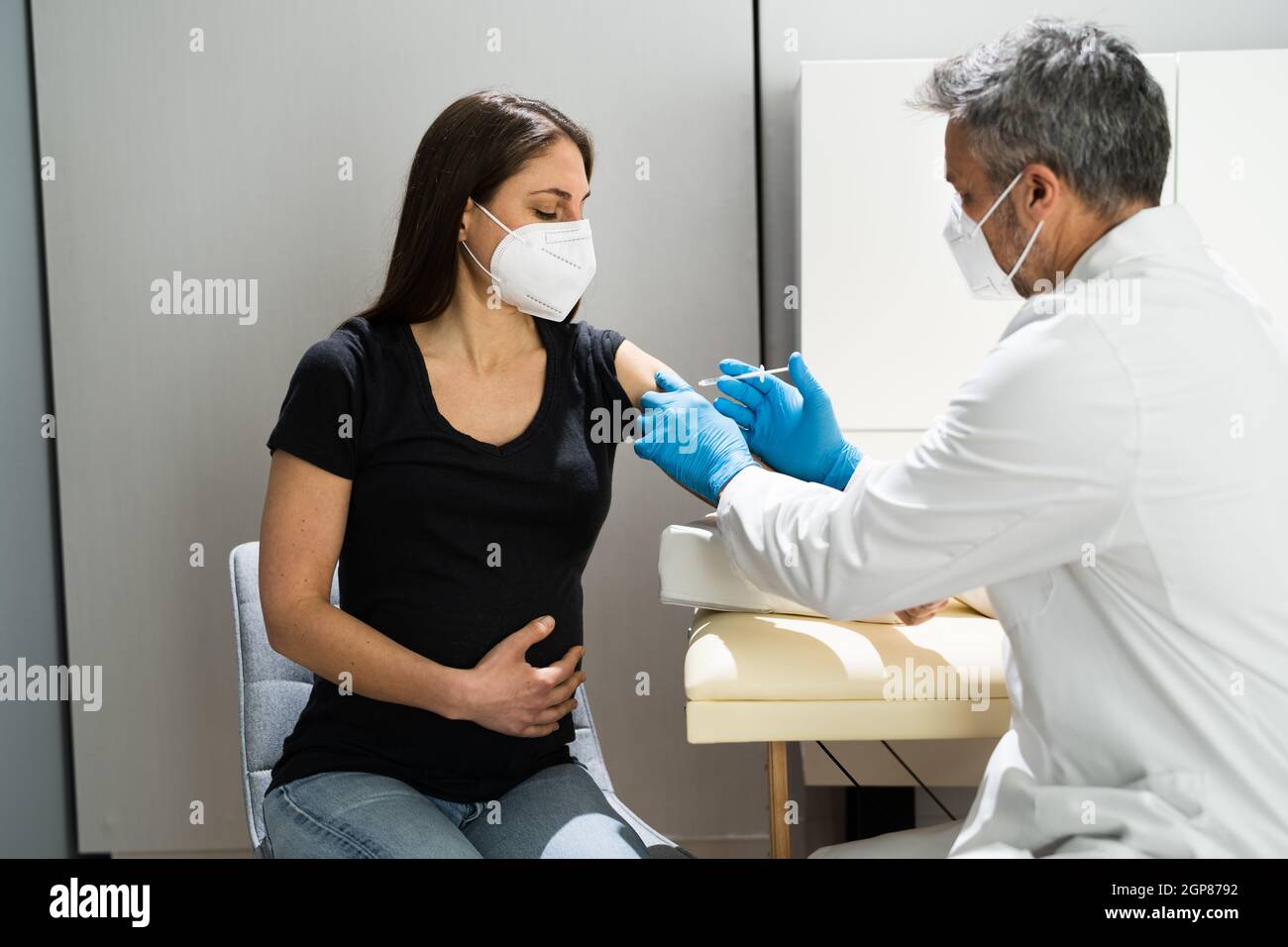 Pregnant Woman Vaccine Injection By Doctor In Face Mask Stock Photo - Alamy