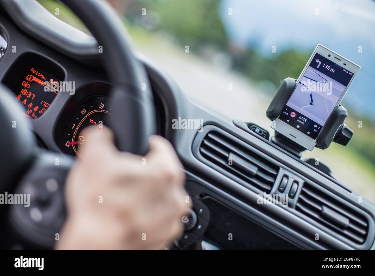 Car dashboard with smartphone used as navigation device, bright and ...