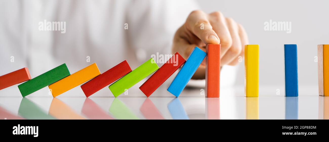 Falling Domino Stop. Fall Prevention. Hand Stopping Stock Photo - Alamy