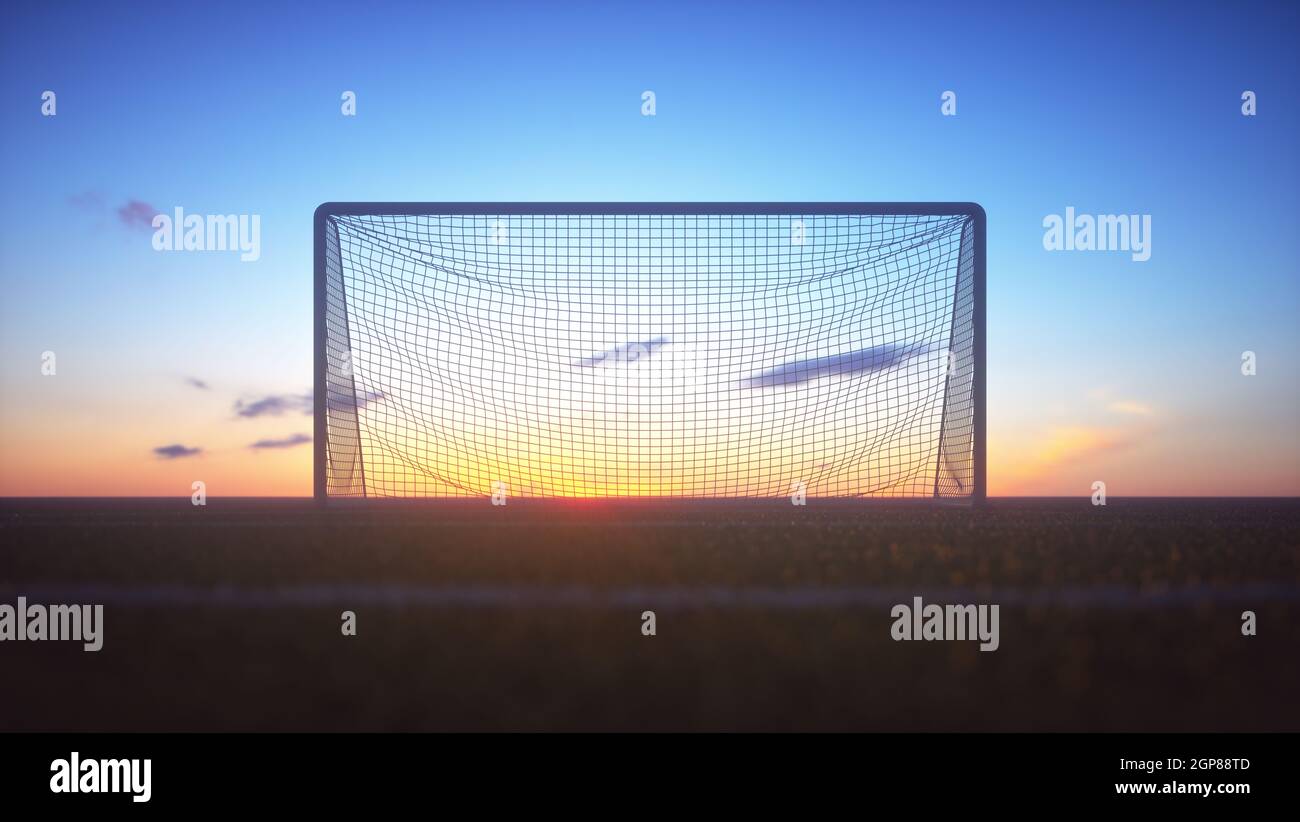 Soccer goal net on the field with the sunset in the background ...