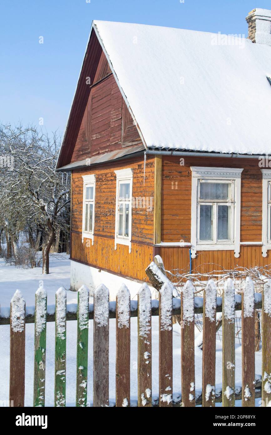 Vintage wooden rural house in Belarus, ornamental windows with carved ...