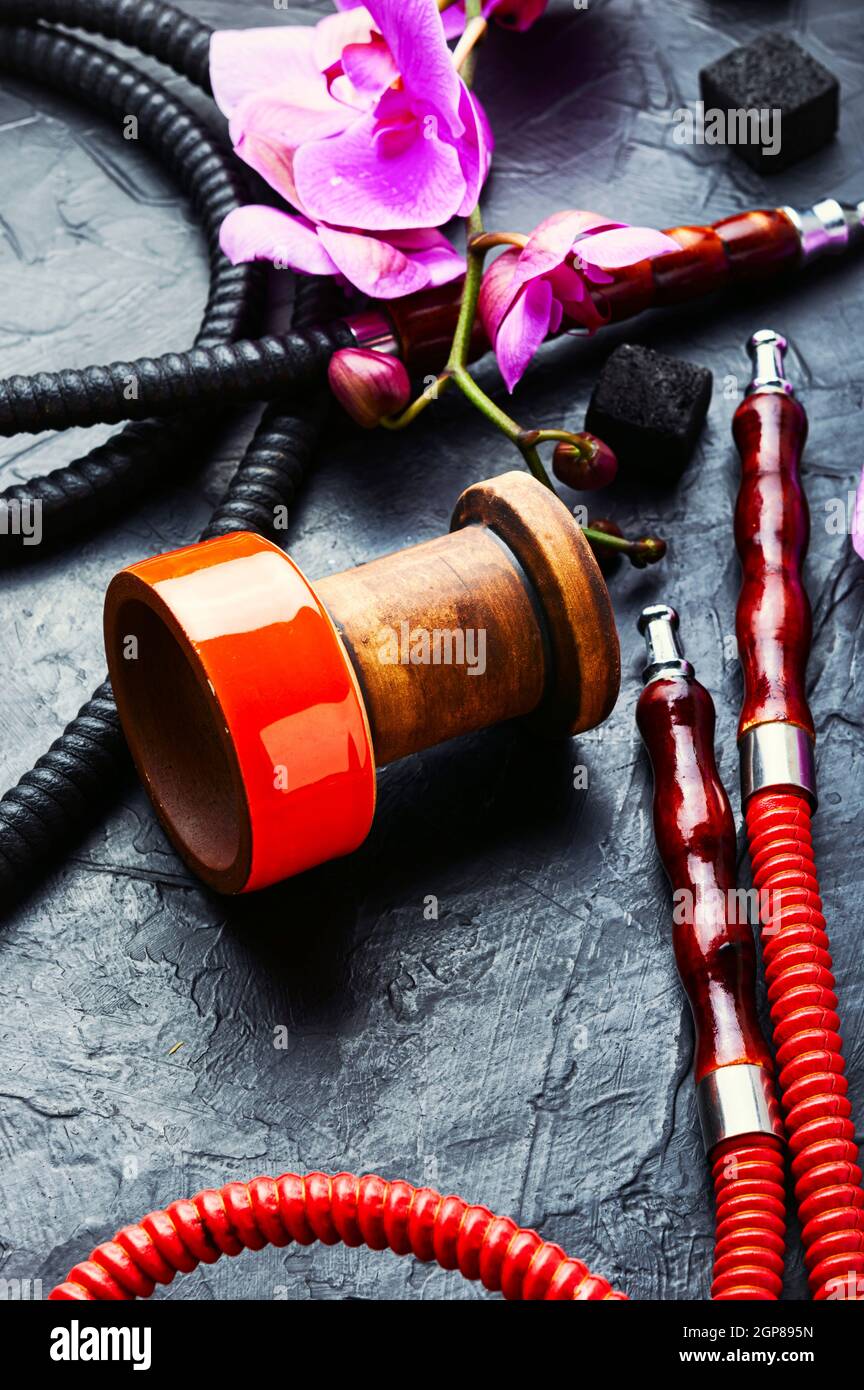 Hookah mouthpiece and hookah cup on pink orchid background.Kalian on ...