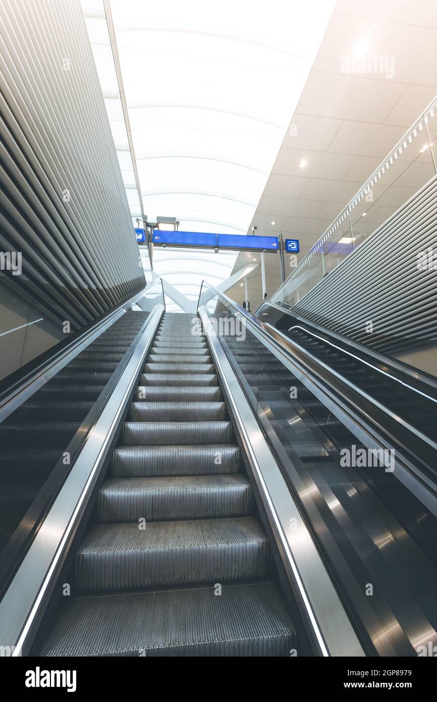 Travelling scene on train station, moving stairway for public transport ...