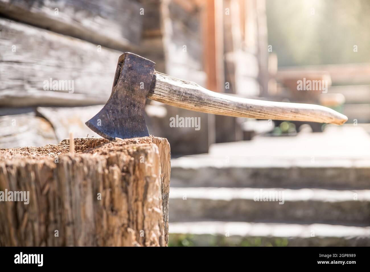 Old axe attached to a tree trunk, alpine hut Stock Photo - Alamy