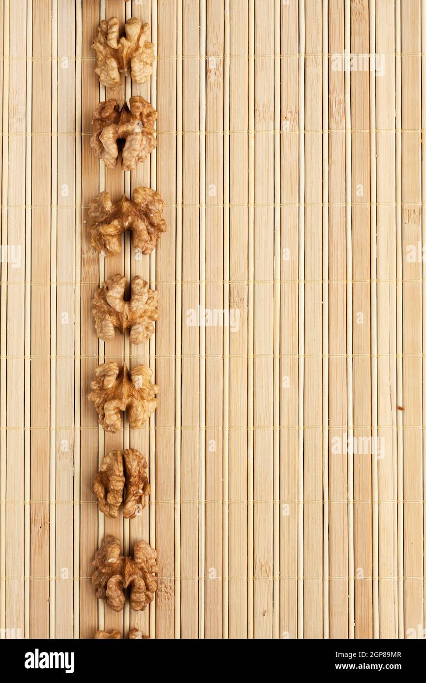 Cases a band of walnut lying on bamboo mat, as background Stock Photo ...