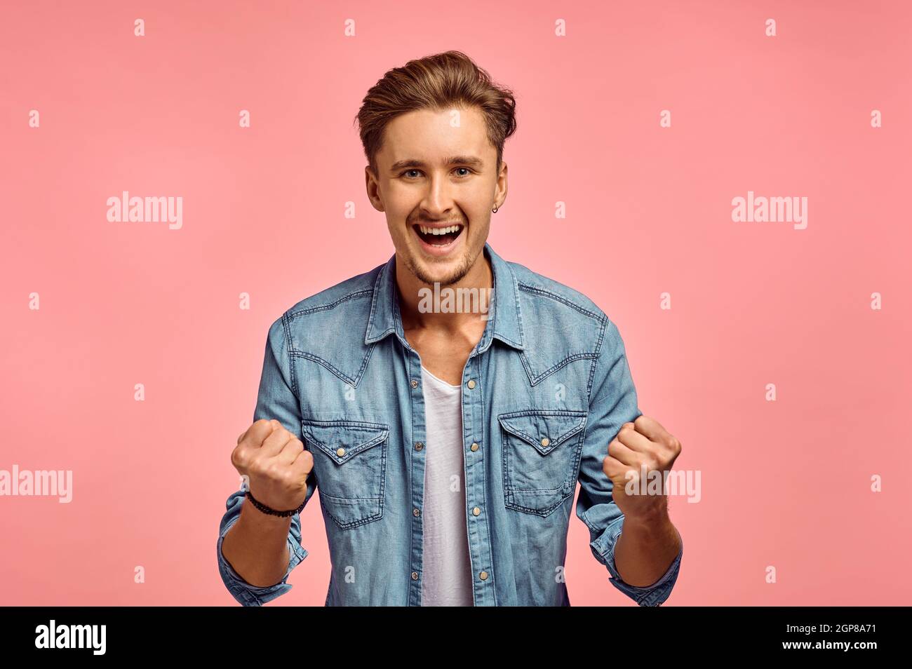 Portrait of a man with an exultant look, pink background, emotion. Face ...