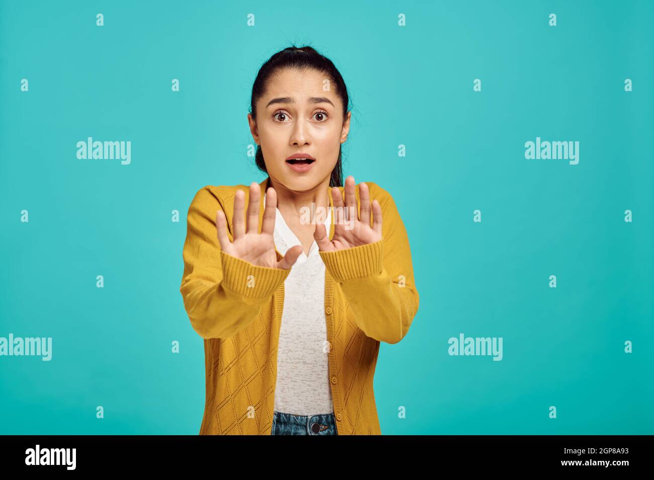 Scared woman portrait, blue background, emotion. Face expression ...