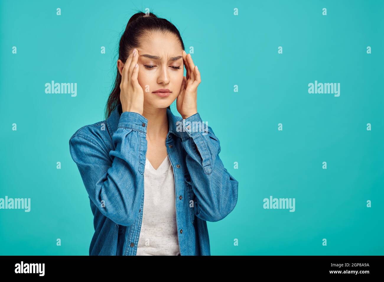 Young sick woman portrait, blue background, negative emotion. Face ...