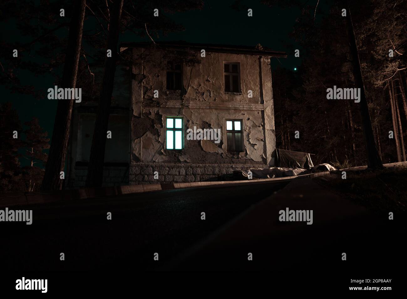 An old mountain house during night poorly lit Stock Photo - Alamy