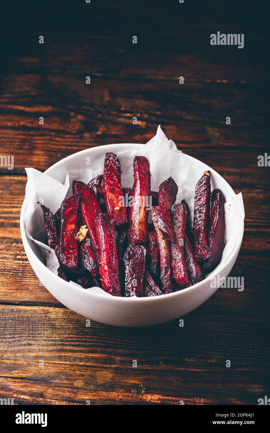 Oven baked beet fries in white bowl Stock Photo - Alamy