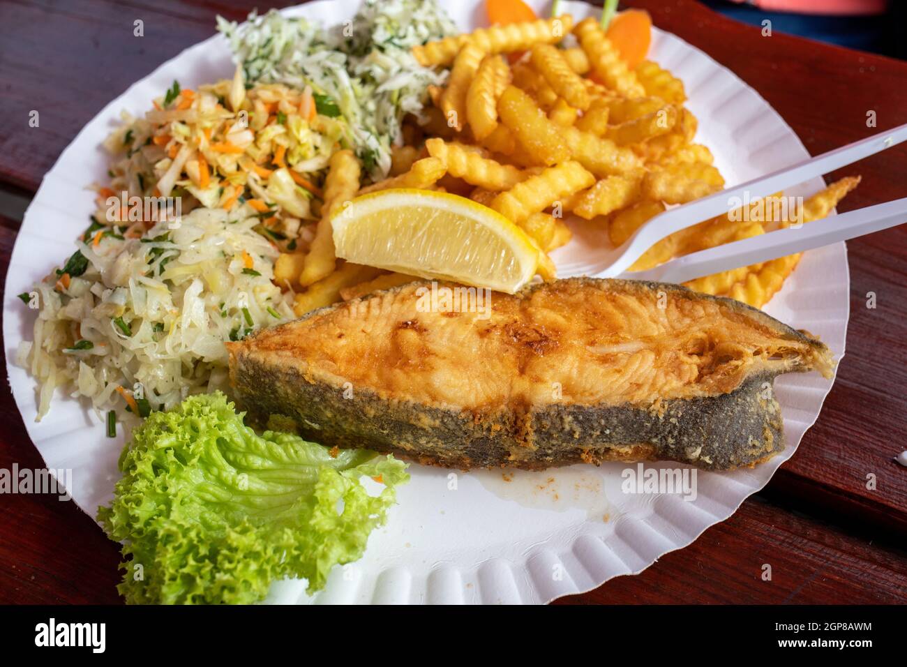 Fried fish with fries and vegetable salad Stock Photo - Alamy