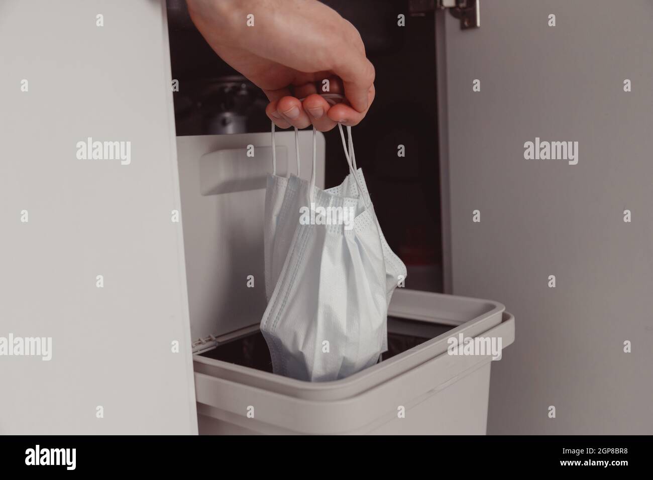 The used face mask is dumped in a trash. Disposal of disposable ...