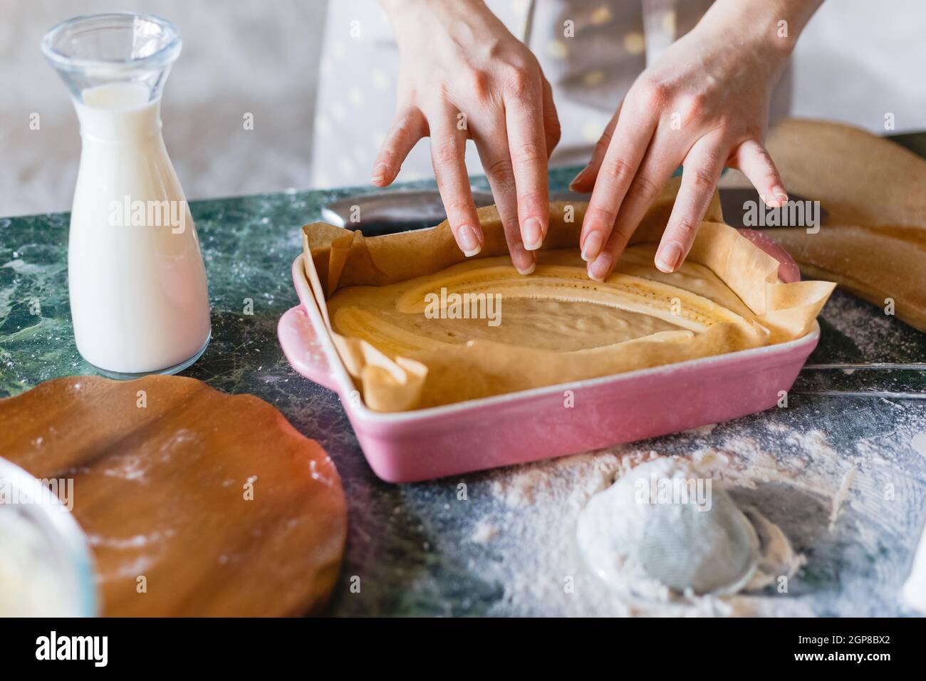 Raw cake batter with halved bananas in ceramic rectangle mould. Banana ...