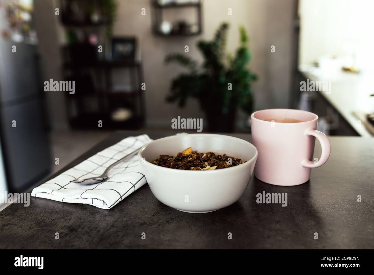 Pink coffee cup, bowl with chopped tropical fruits kiwi and banana ...