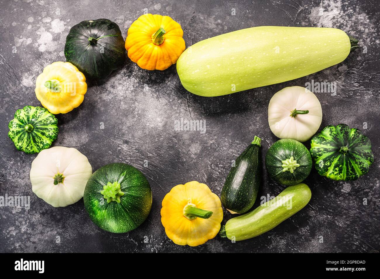 Summer squashes on textured concrete backdrop with copyspace, top view ...