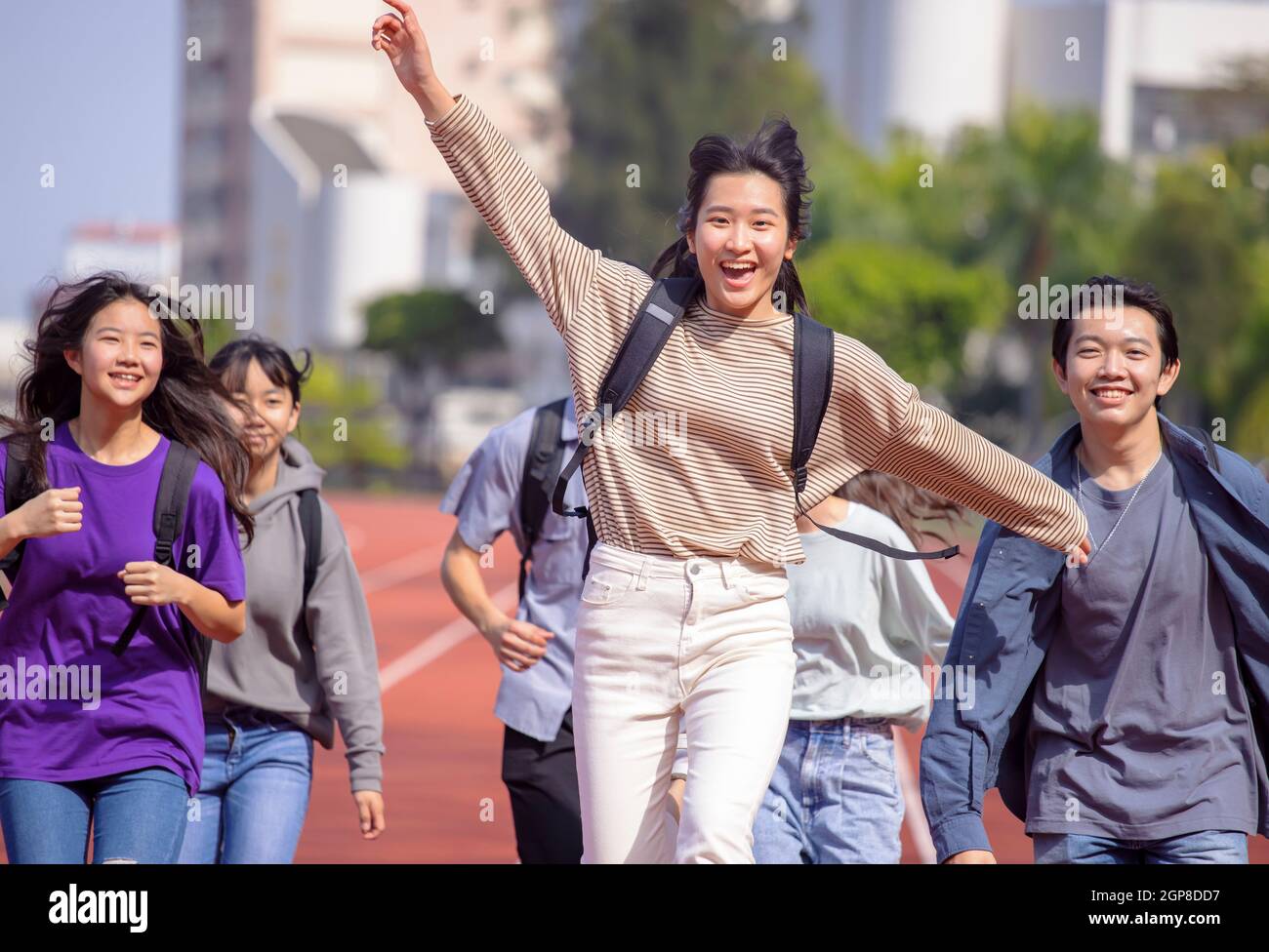Happy young group students running Across Field Stock Photo - Alamy