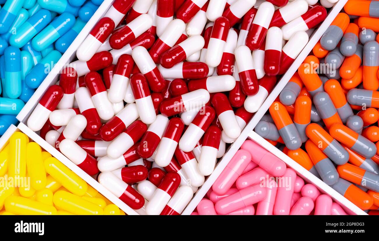 Top view capsule pills in plastic box. Multi colored capsule pills ...